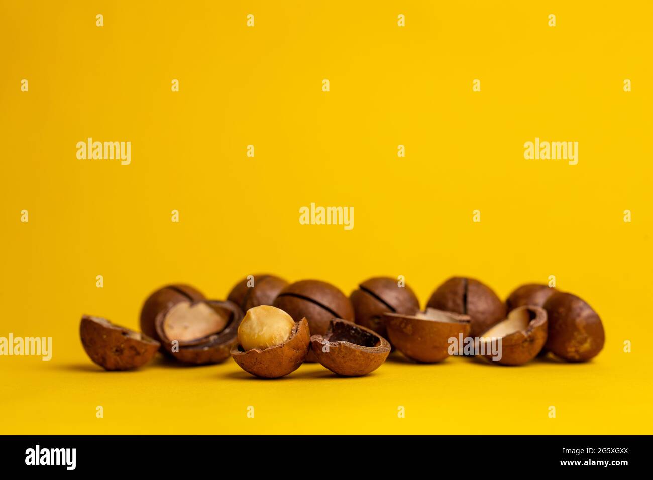 the most delicious macadamia nut on a yellow background Stock Photo - Alamy