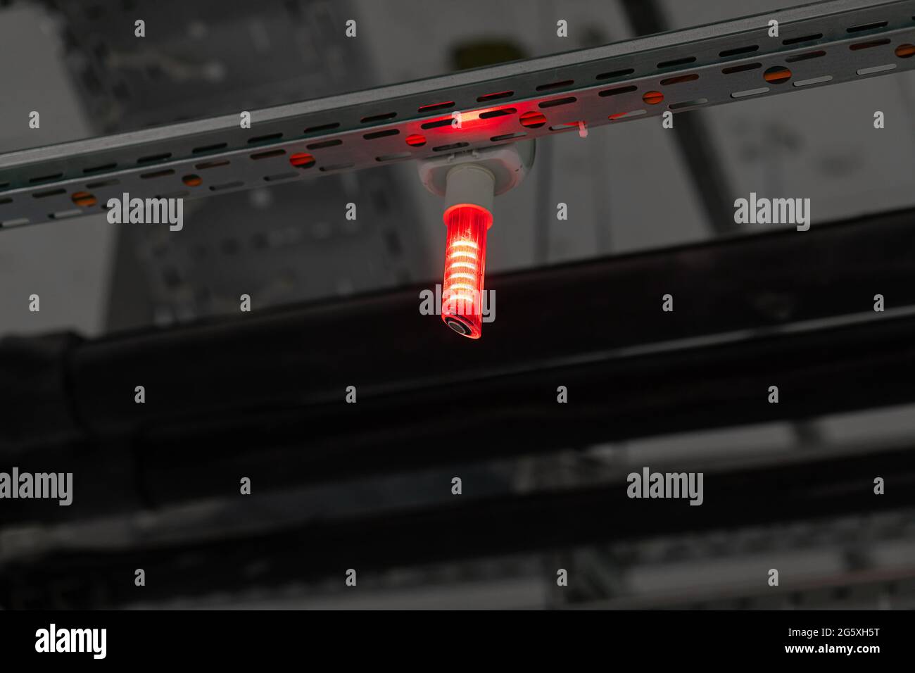 Red parking sensor on ceiling - space is taken. Smart parking concept ...