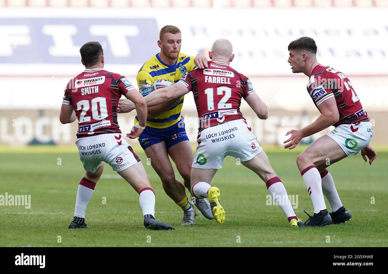 Warrington Wolves' Jack Hughes in action with Wigan Warriors' Harry ...