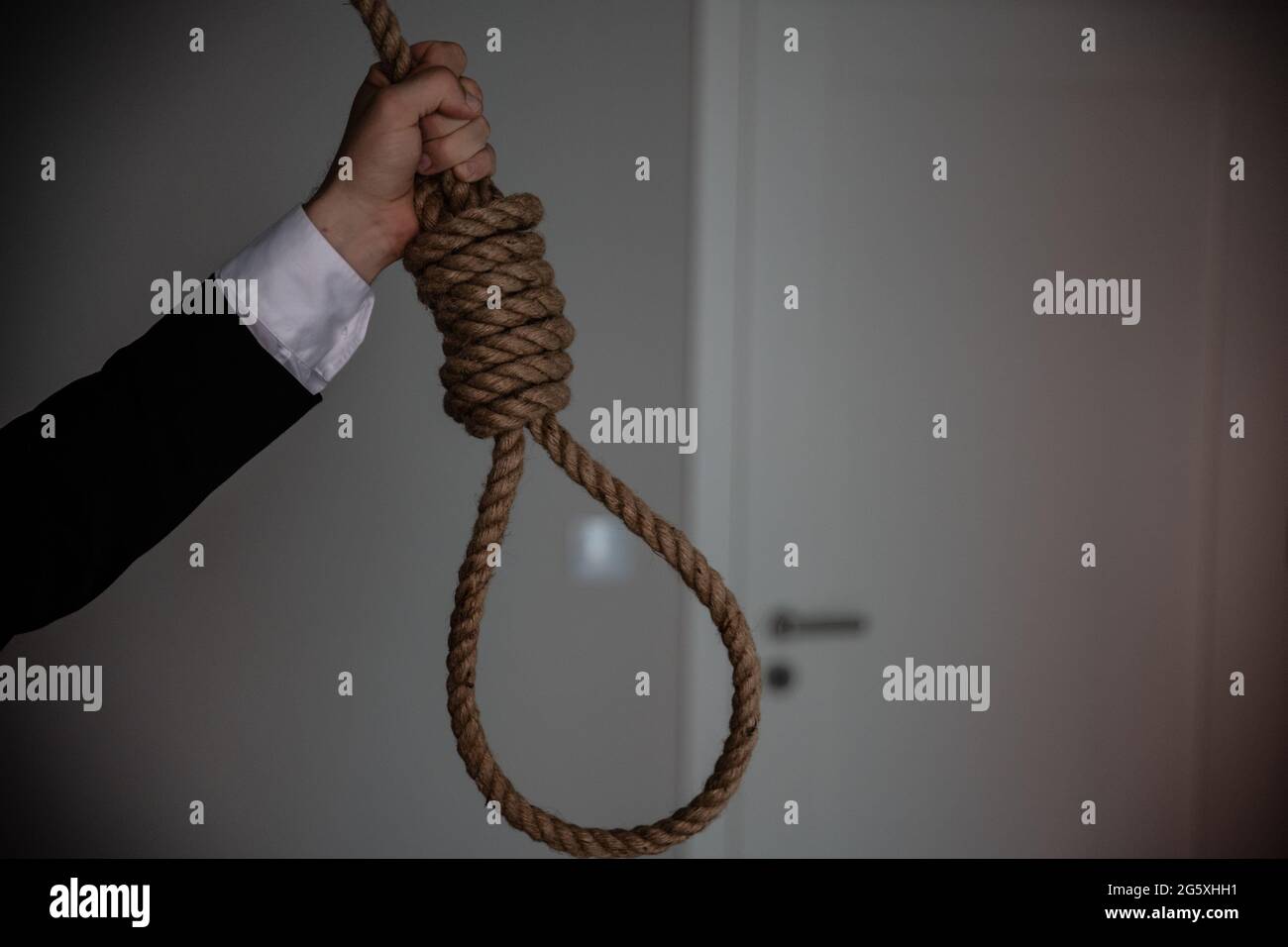 Suicide prevention concept. Hand holding a rope Stock Photo - Alamy