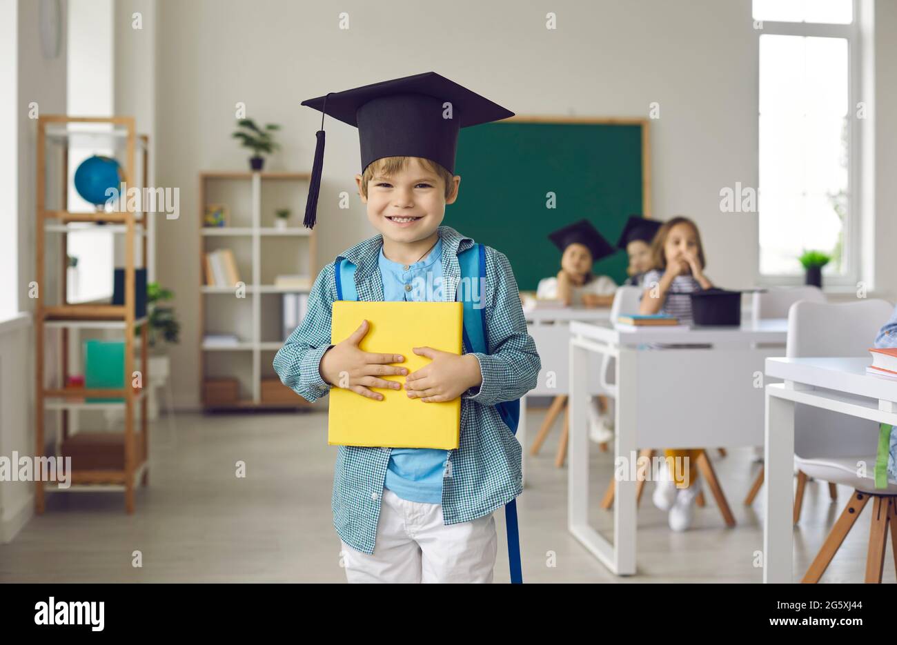Half-length portrait of happy smiling elementary school boy in ...