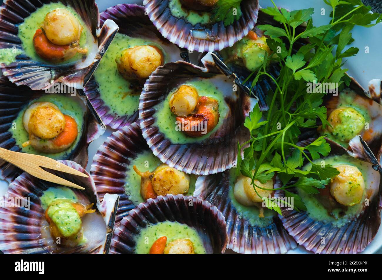 grilled scallops with green sauce and parsley Stock Photo - Alamy