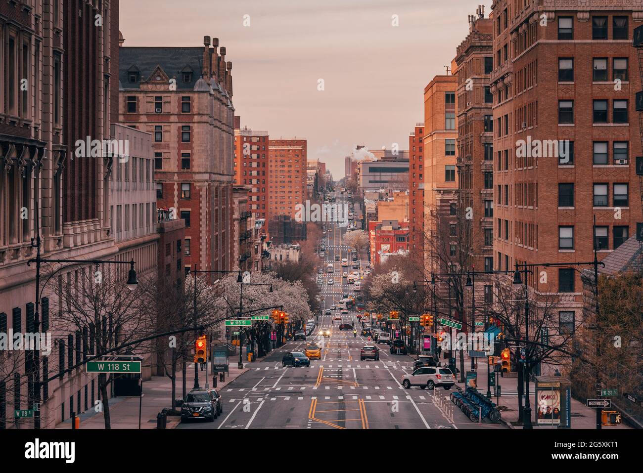 A city street with tall buildings at sunset - Amsterdam Avenue from ...