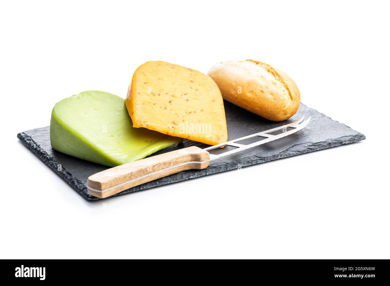 Block of hard cheese with chili and wasabi flavor on cutting board ...