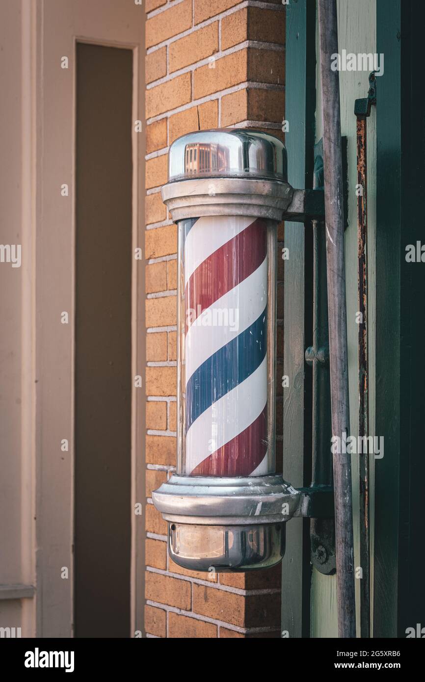 A red white and blue striped barbers pole Stock Photo - Alamy