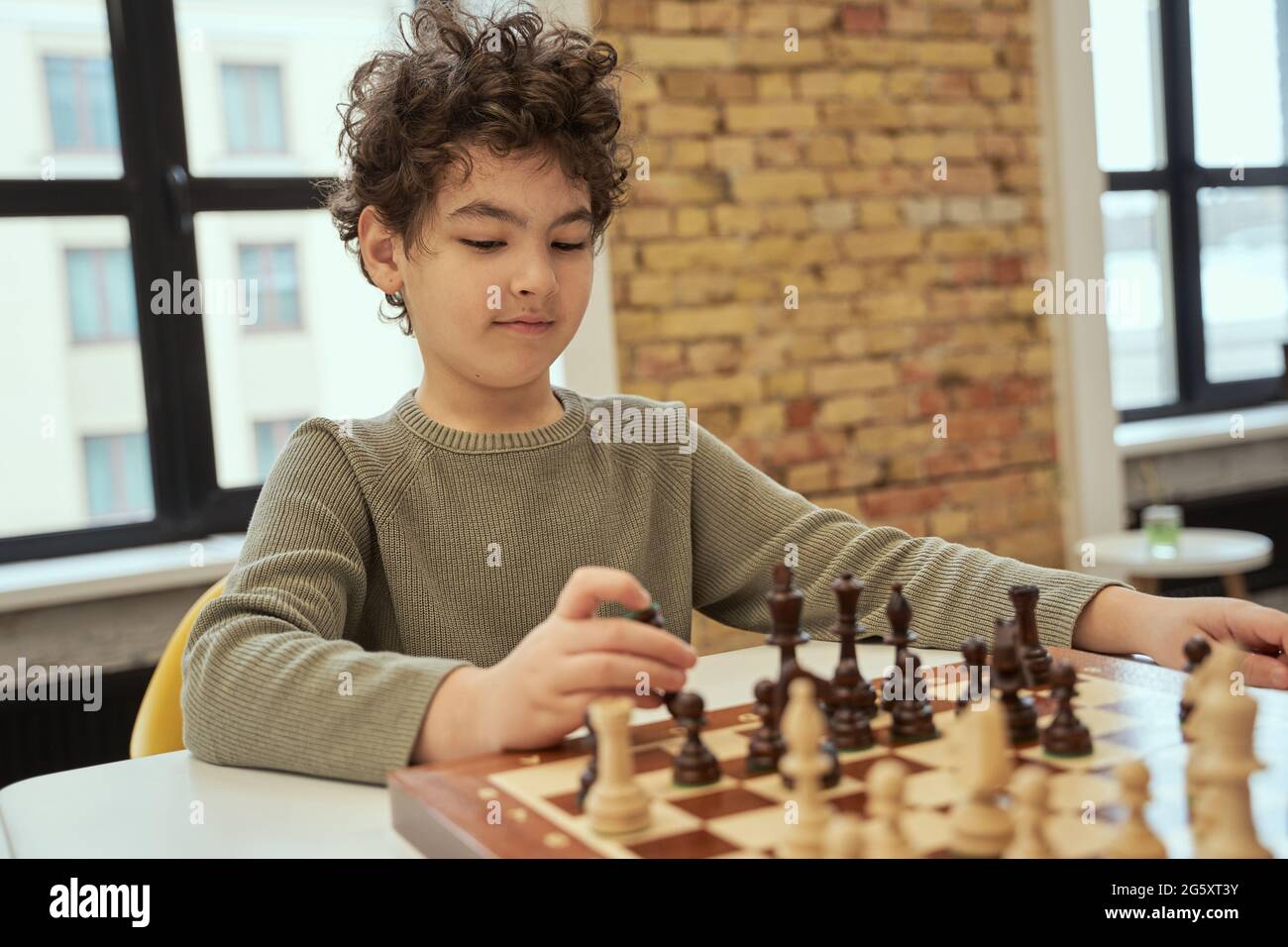 Just play. Smart kid sitting in the classroom and planning a move while ...