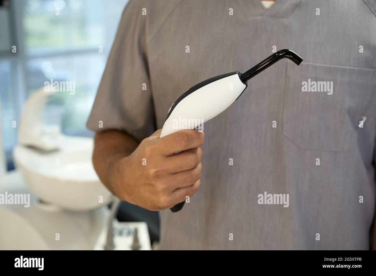 Dental technician posing with device for laser curing Stock Photo - Alamy