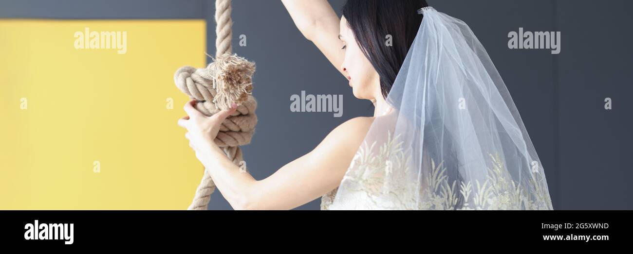 Woman in wedding dress holds her hand on loop for neck Stock Photo - Alamy