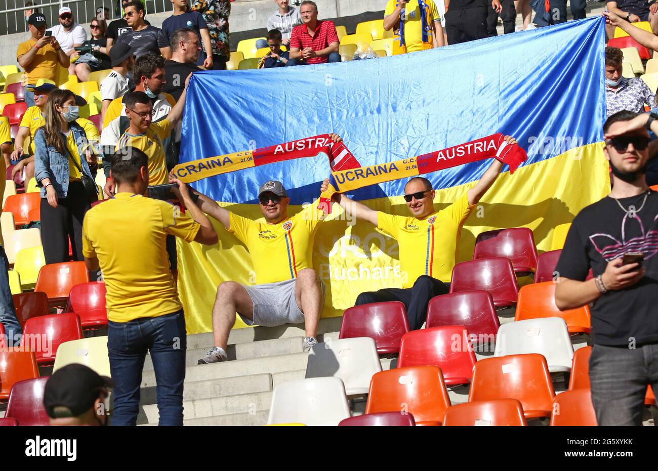 BUCHAREST, ROMANIA - JUNE 21, 2021: Football fans pose for a photo with ...
