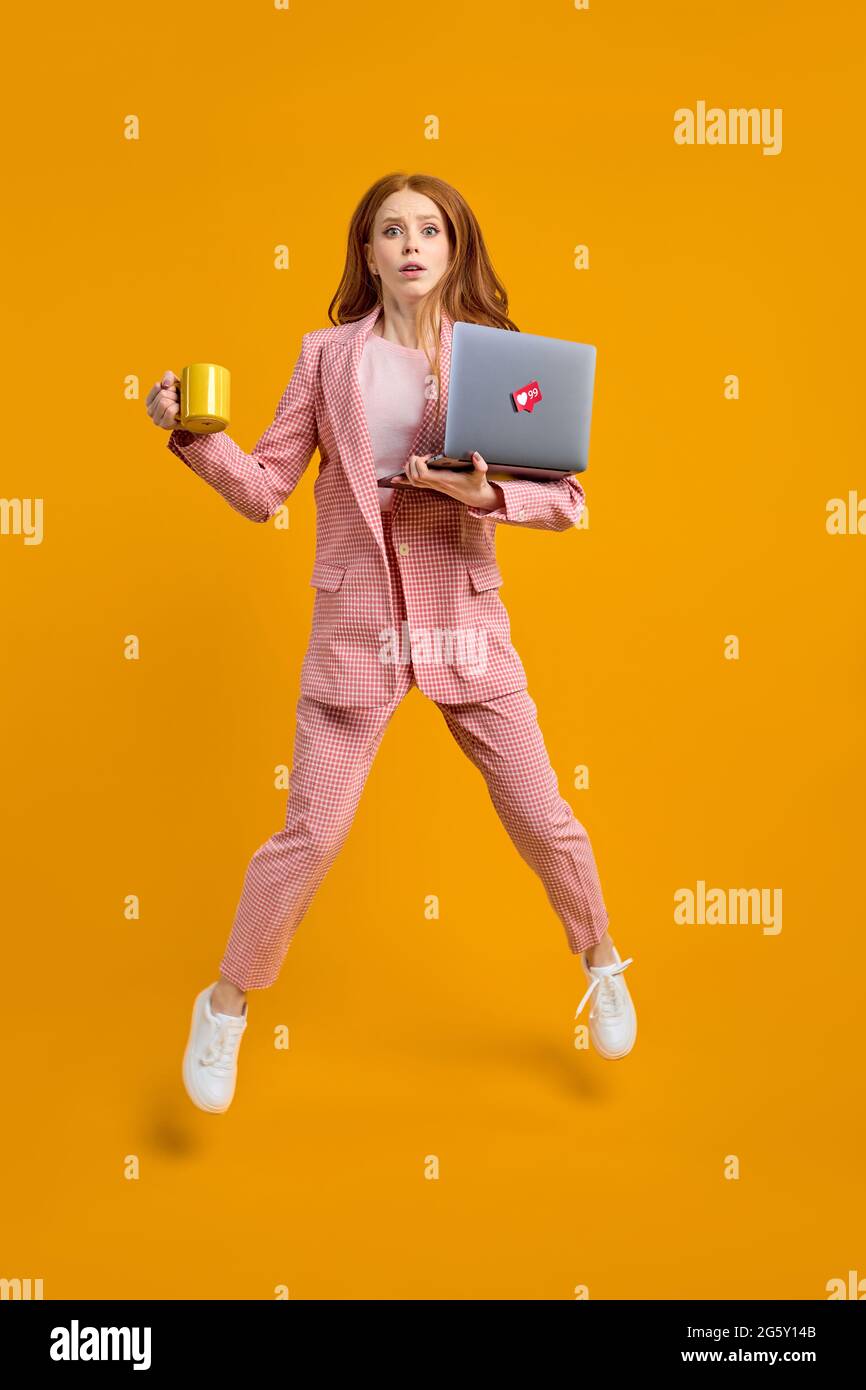 Worried nice redhead successful woman leader jumping in air carrying ...
