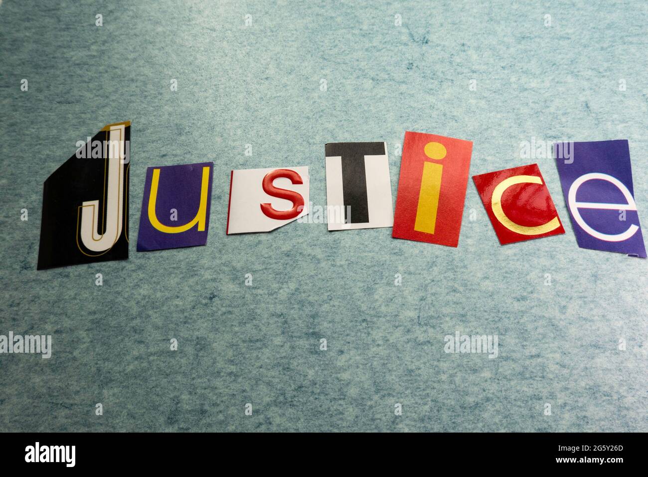 The word "Justice" using cut-out paper letters in the ransom note ...