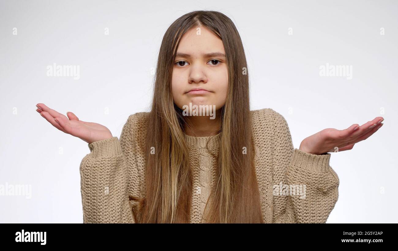 Portrait of doubtful girl showing confusion gesture with hands Stock ...