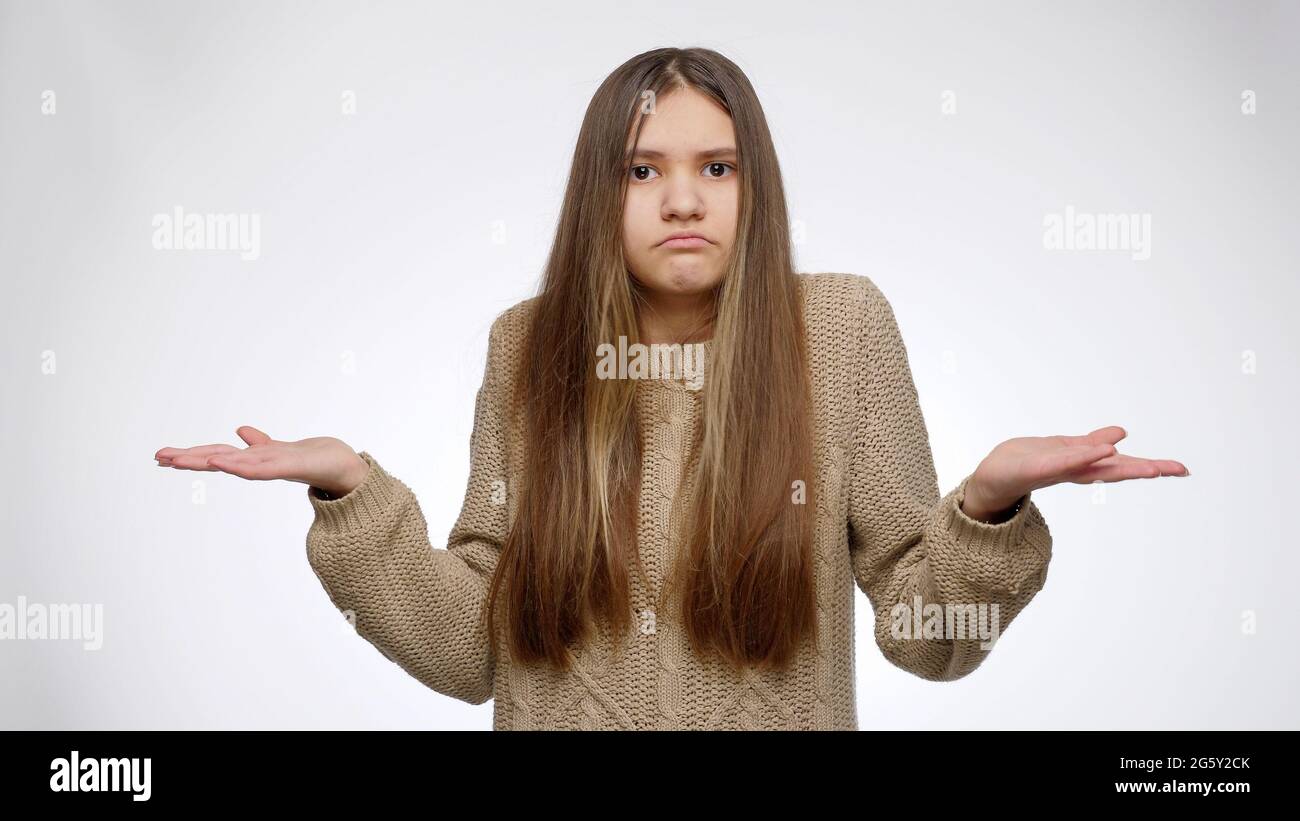Portrait of puzzled girl lost and looking for something in pockets over ...
