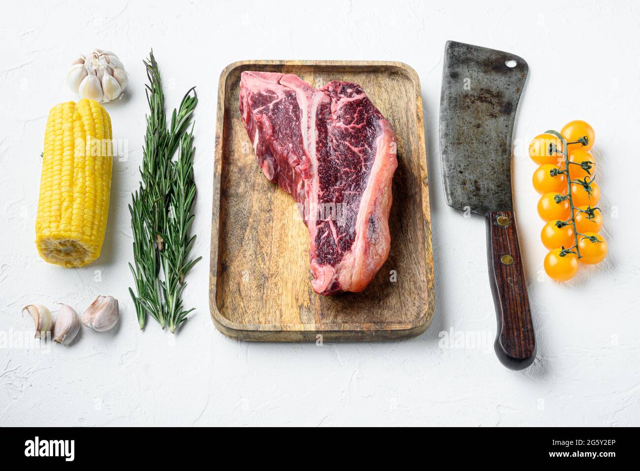 Cooking meat background. Raw aged beef t-bone steak, with spices and ...