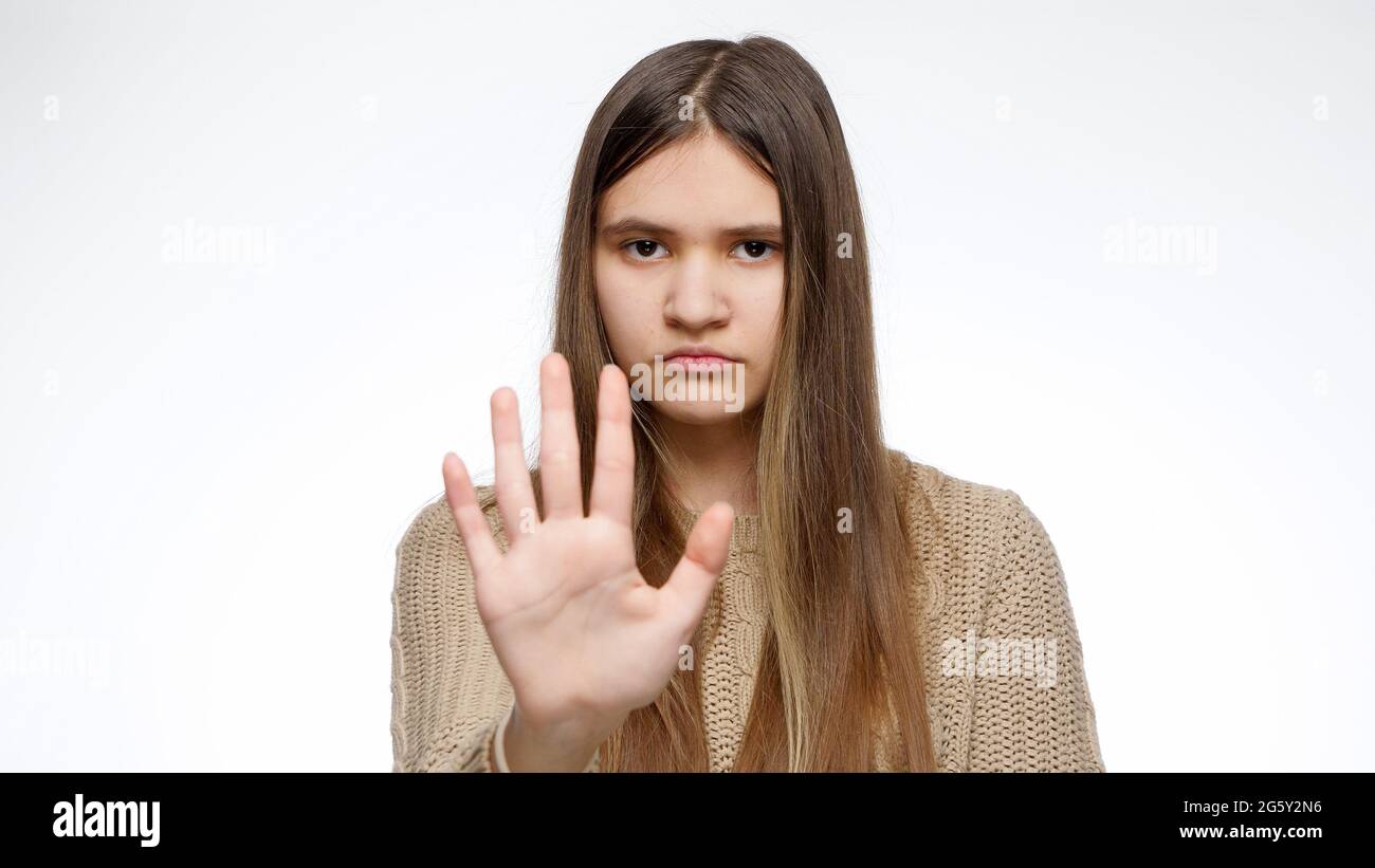 Stop or no sign. Girl showing refuse or deny gesture with hand over ...