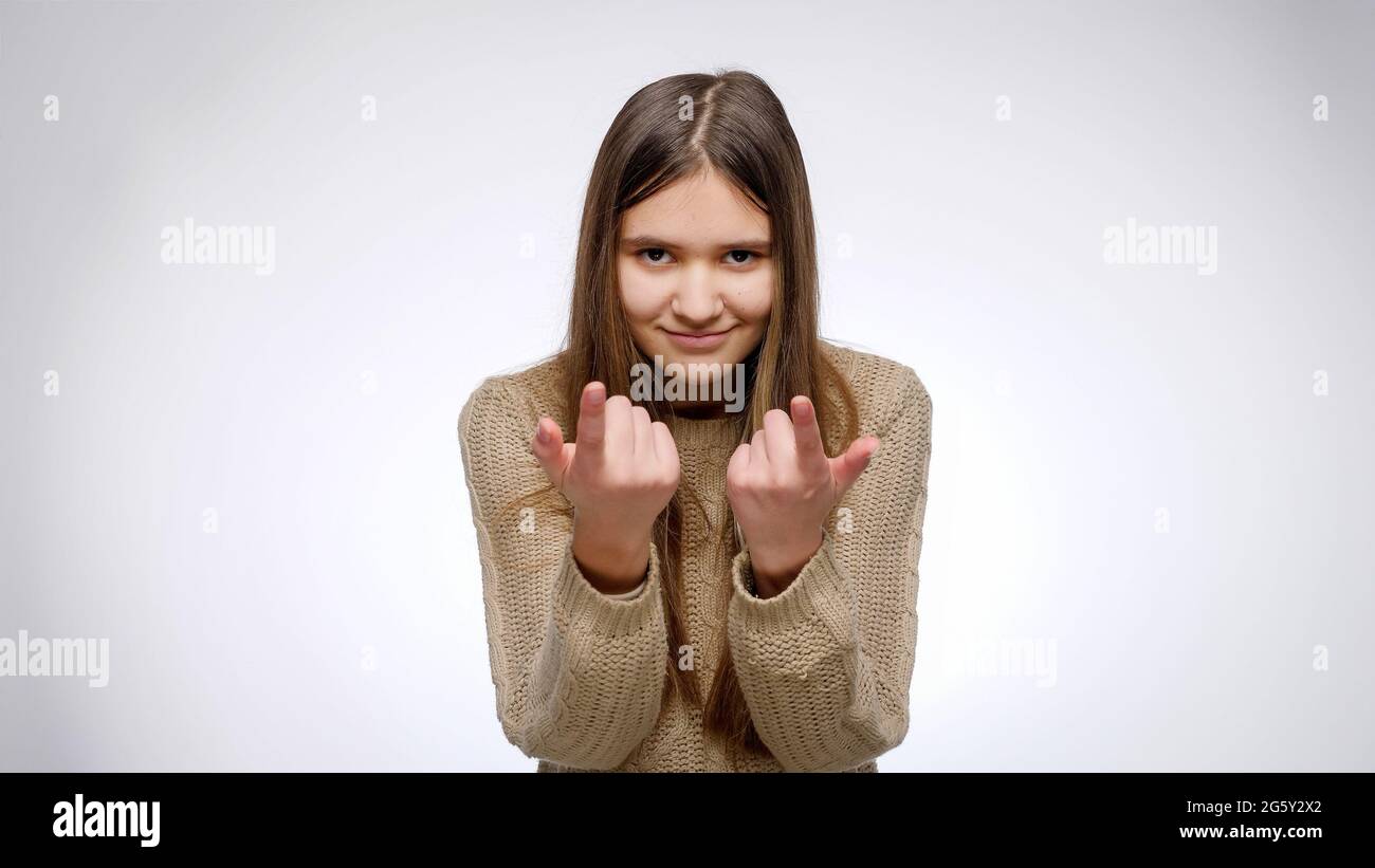 Young girl calling and inviting you over white studio background Stock ...