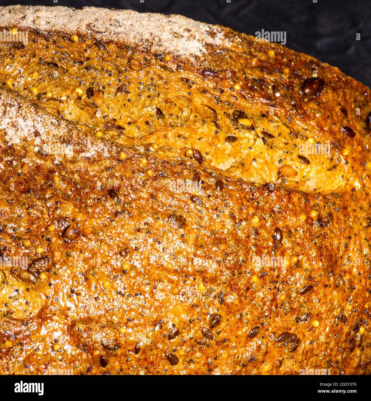 Slice of rustic natural yeast-free bread with flax, poppy seeds, sesame ...