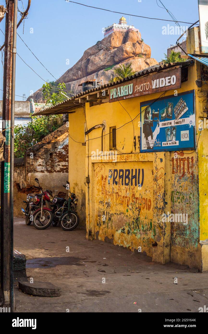 Colourful yellow commercial building with Rockfort Temple in distance ...