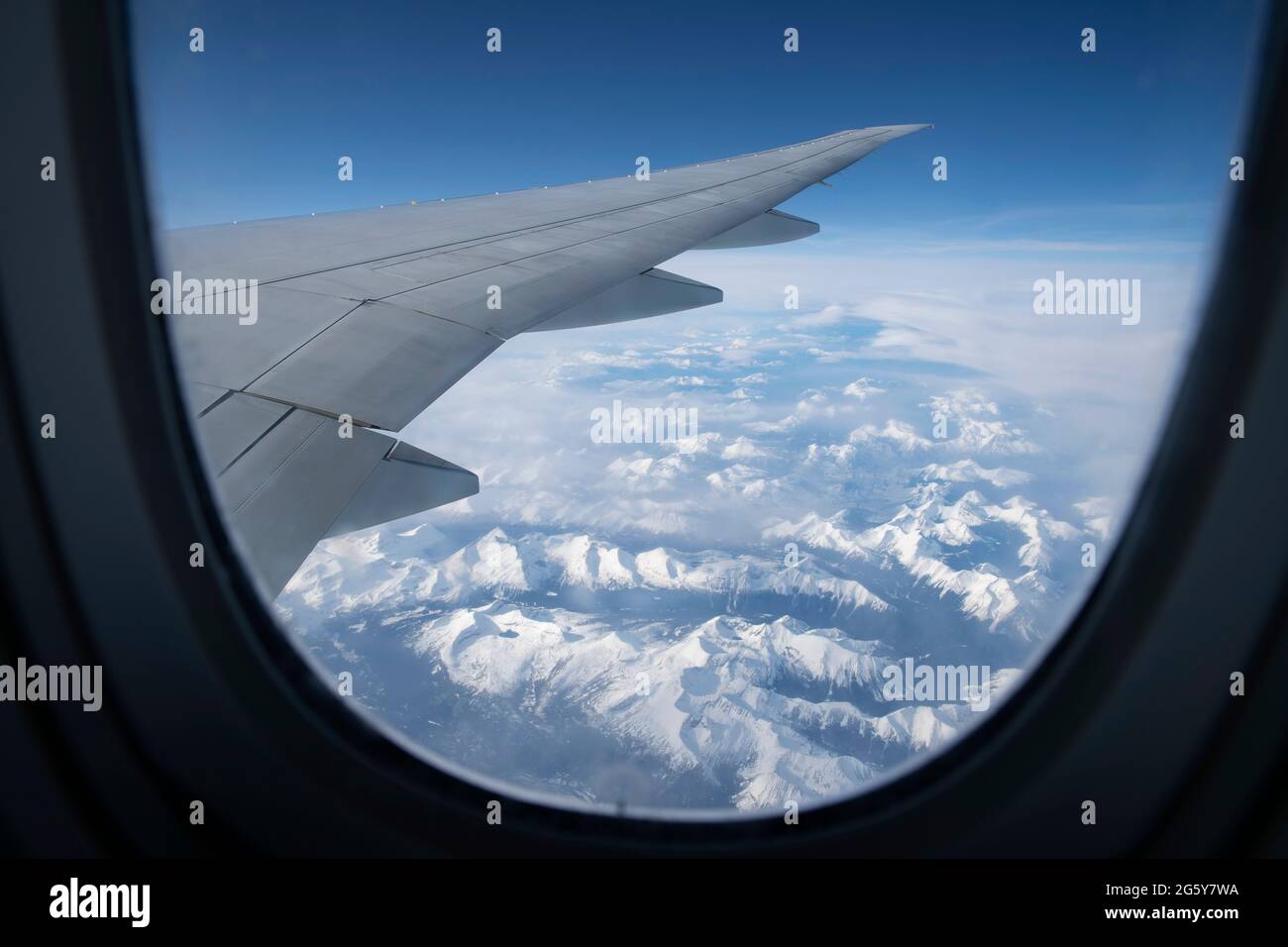 Snowy mountains in Canada seen from a plane window Stock Photo - Alamy
