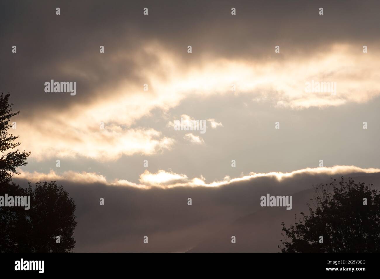Sunlight breaking through storm clouds in this dramatic lighting of the ...