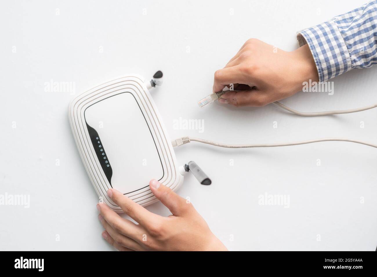 hand conncecting the ethernet wire cable with wi-fi remote point Stock ...