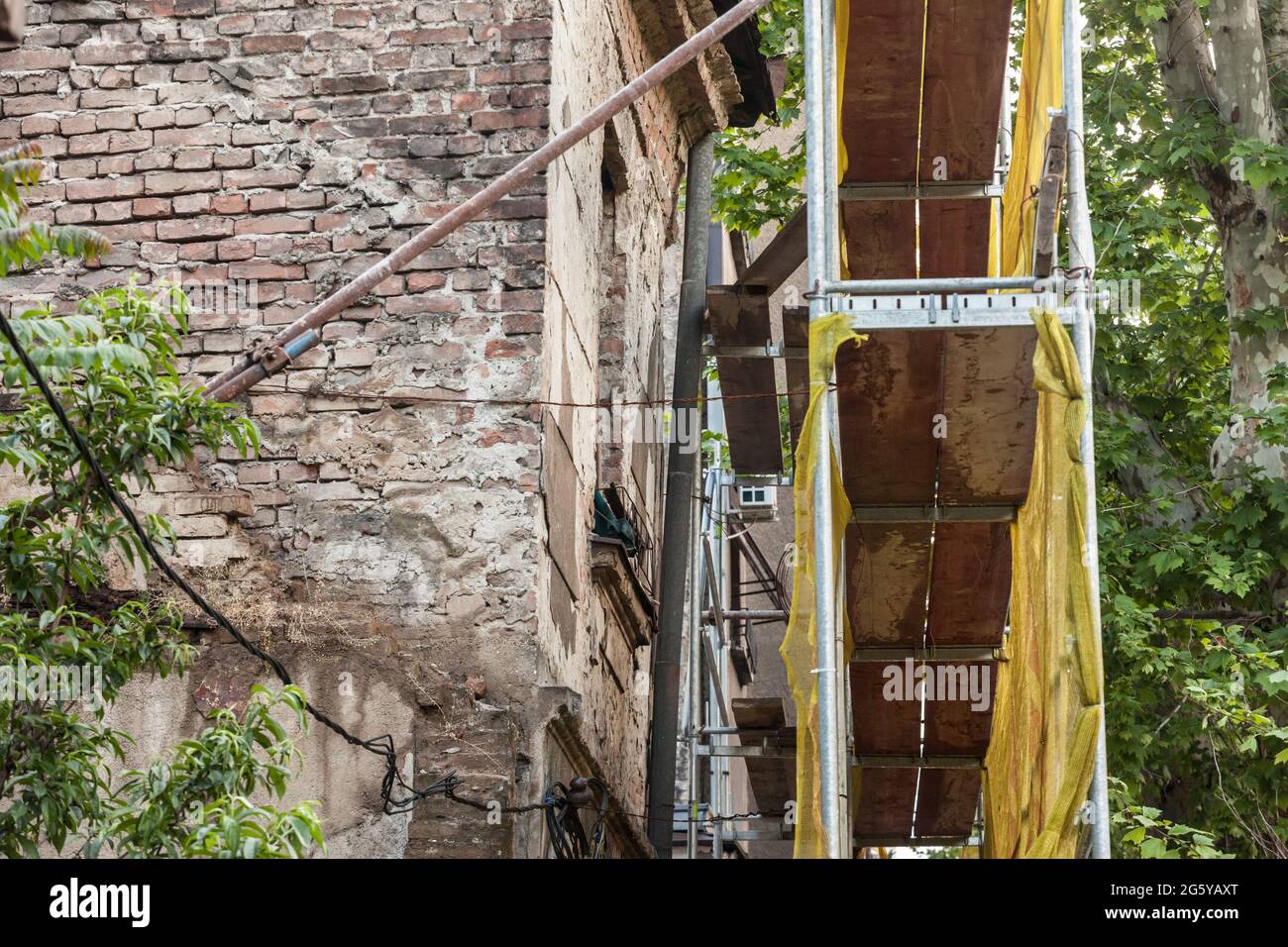 Picture of a damaged house protected with scaffoldings before a ...