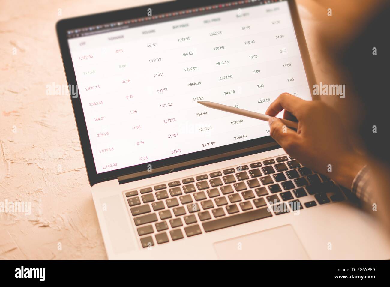 close up businessman hand with pan looking through the details of stock ...