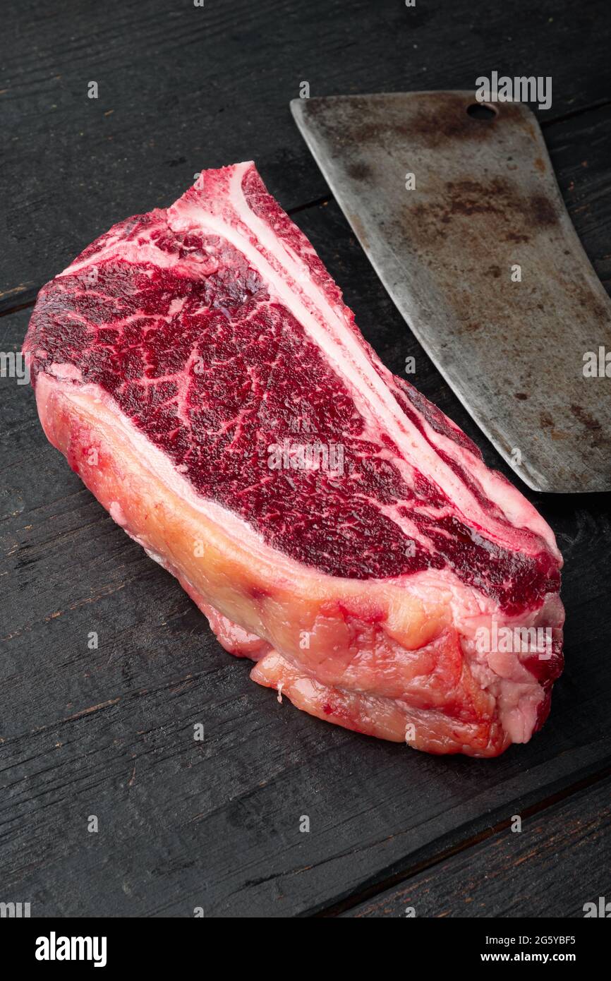 Raw beef club steak dry aged set, on black wooden table background ...