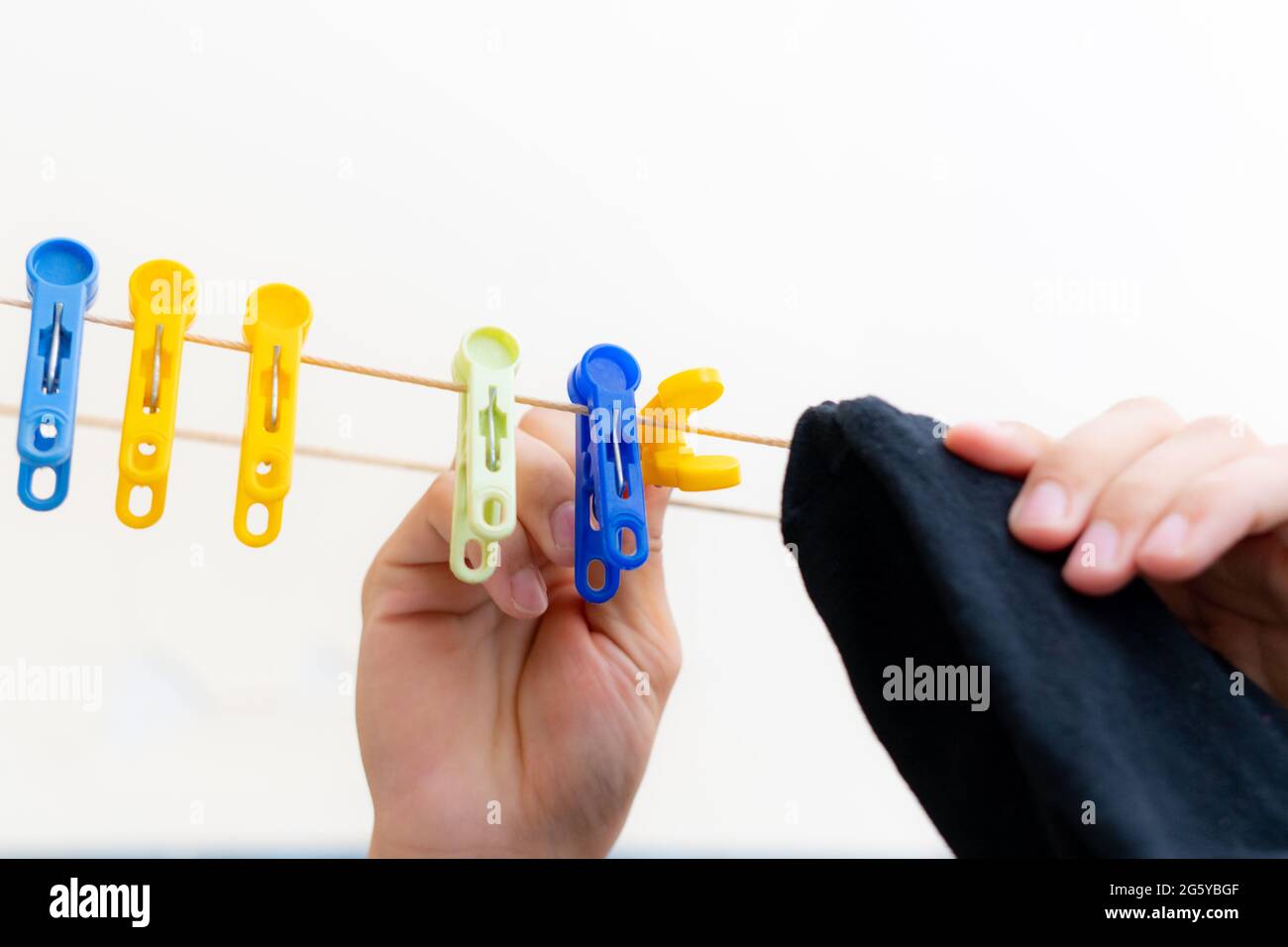 Man hanging up laundry hi-res stock photography and images - Alamy