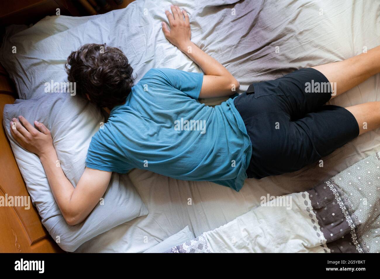 person's wrong position during the sleep in bed, bad posture Stock ...