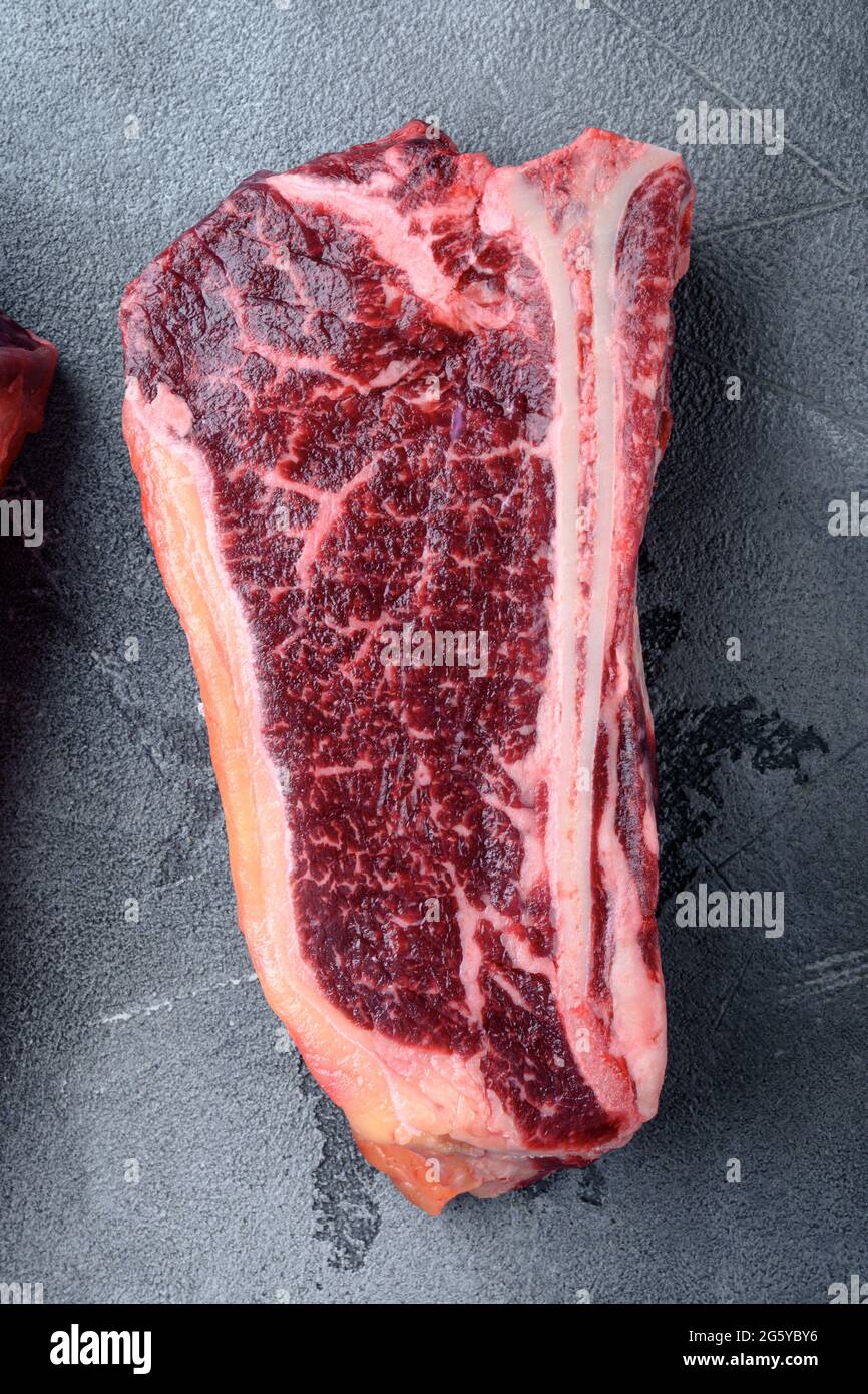 Thick fatty marbled raw beef club steak set, on gray stone background ...