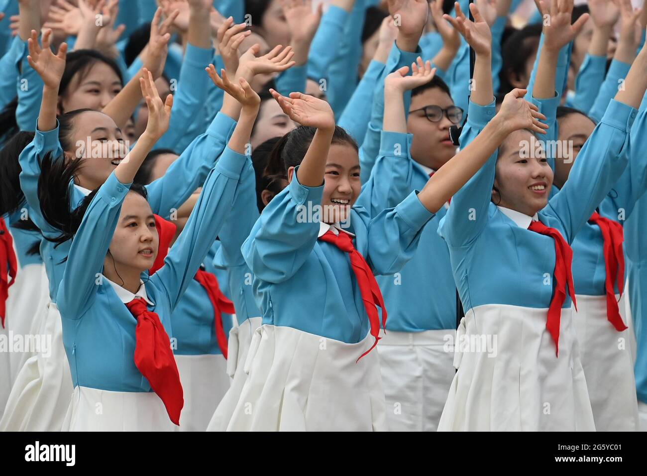 Beijing, China. 1st July, 2021. Choir members wave hands ahead of a ...