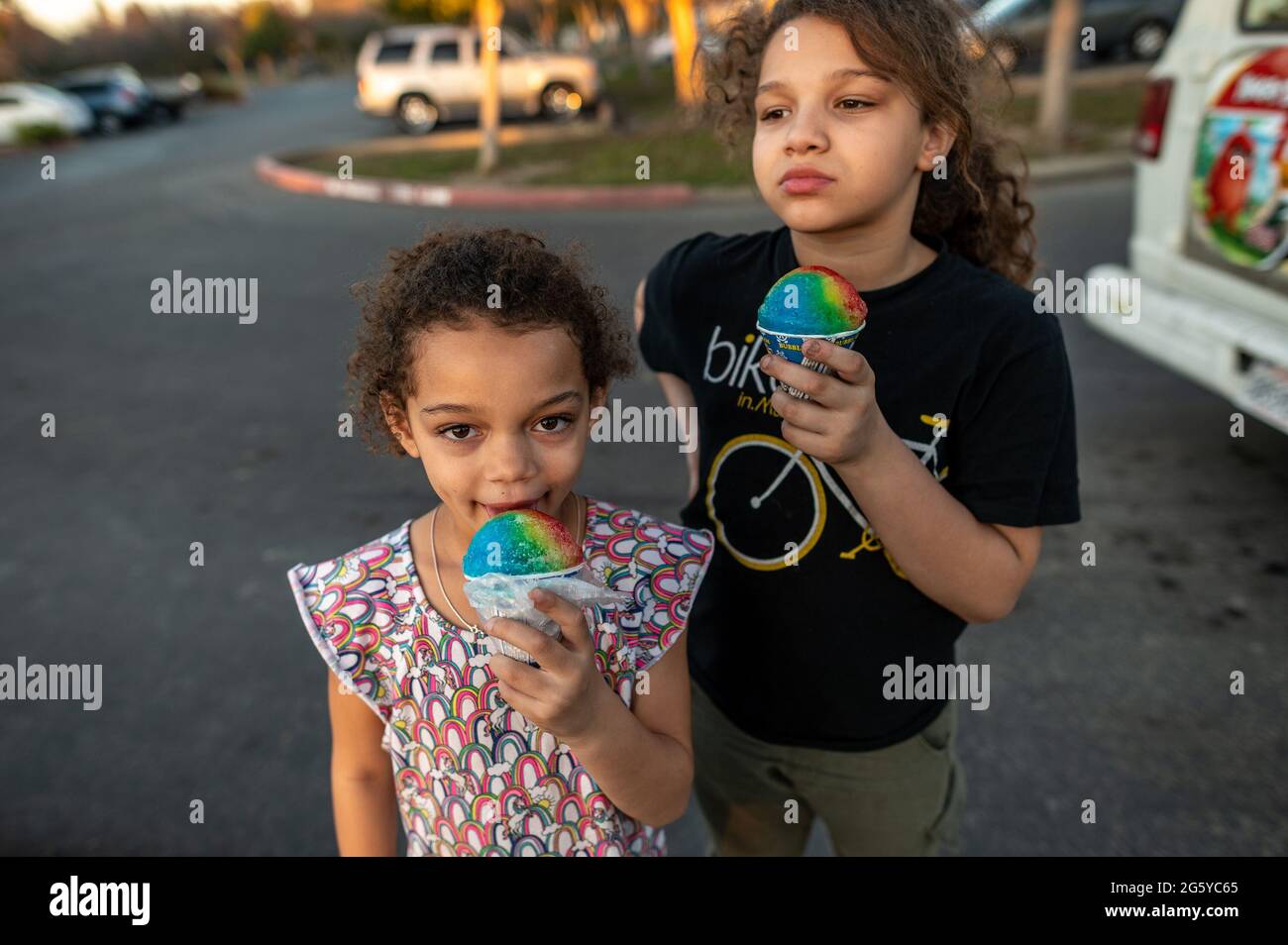 Aryanna Slain, 8, right, and Shyann Slain, 7, left, enjoy snow cones at ...
