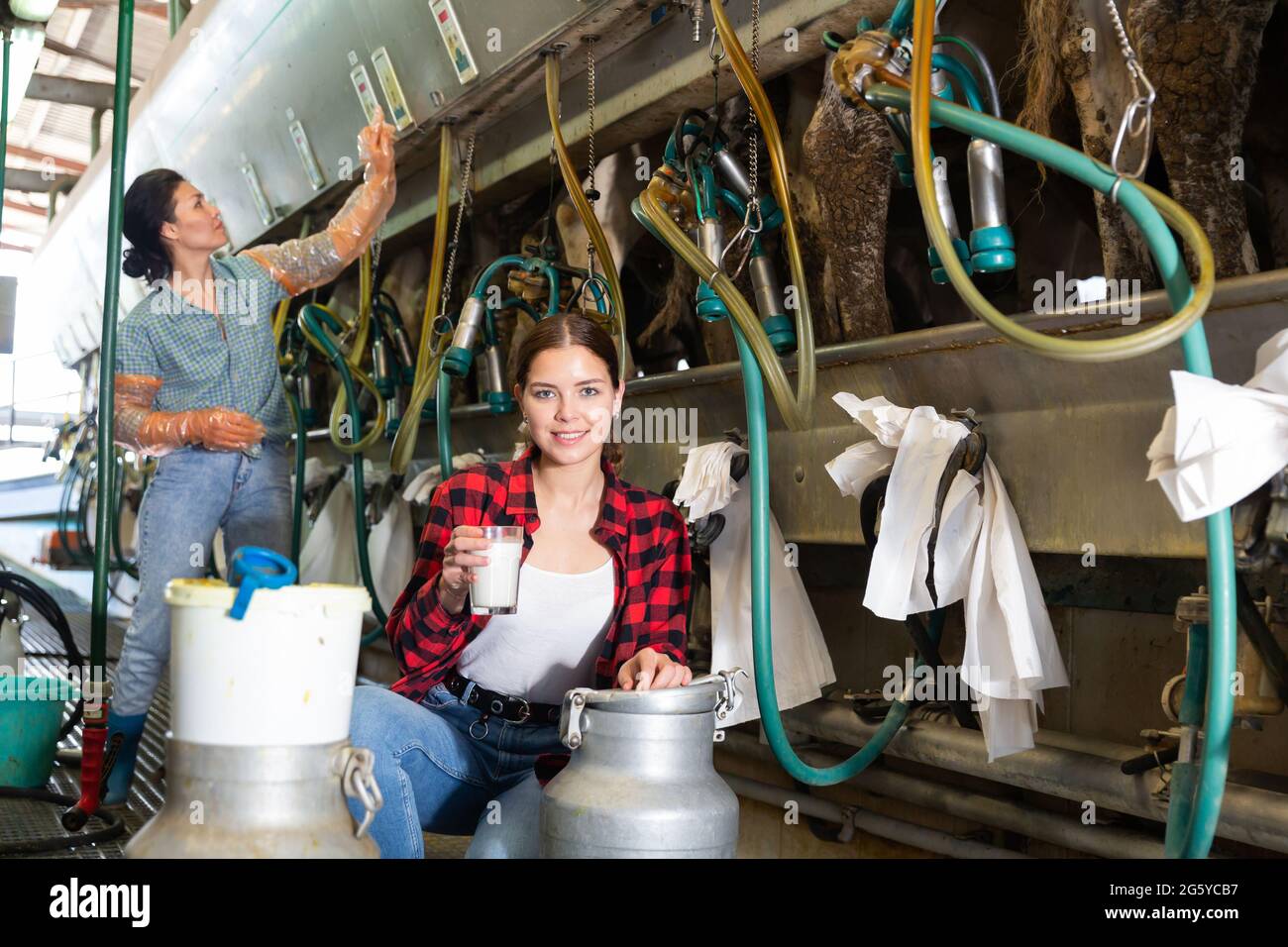 Female milker posing with glass of milk on dairy farm Stock Photo - Alamy