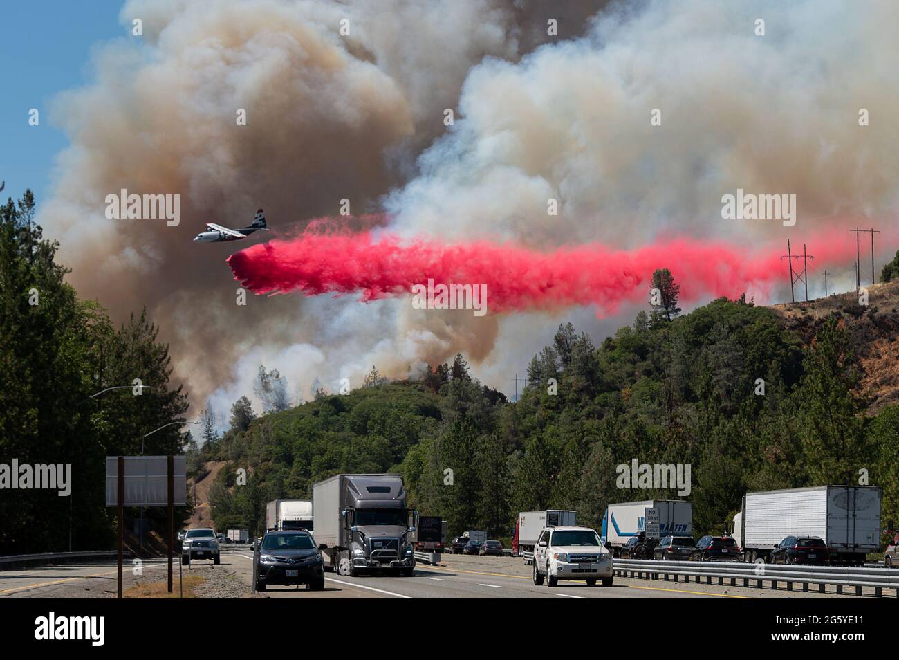 Lake Shasta, CA, USA. 30th June, 2021. An air-tanker drops fire retarded on the Salt Fire to the ...