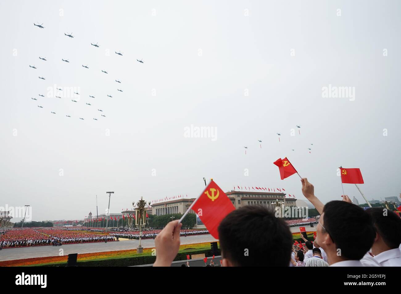 Beijing, China. 1st July, 2021. Helicopters fly in echelons ahead of a ...