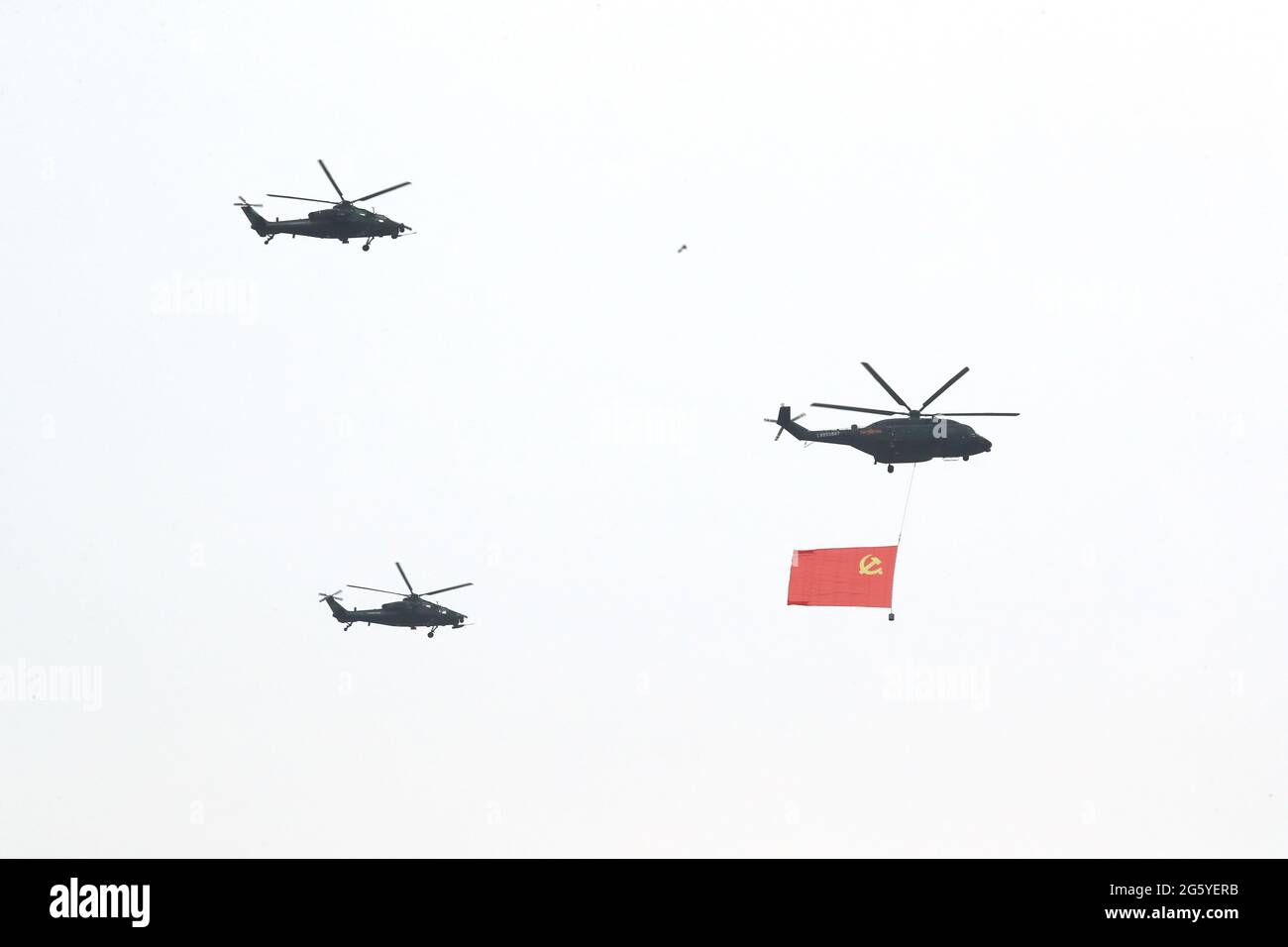 Beijing, China. 1st July, 2021. Helicopters fly in echelons ahead of a ...