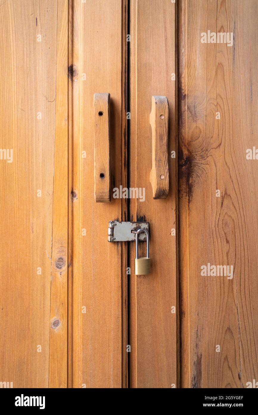 Double wooden door locked with a key Stock Photo - Alamy