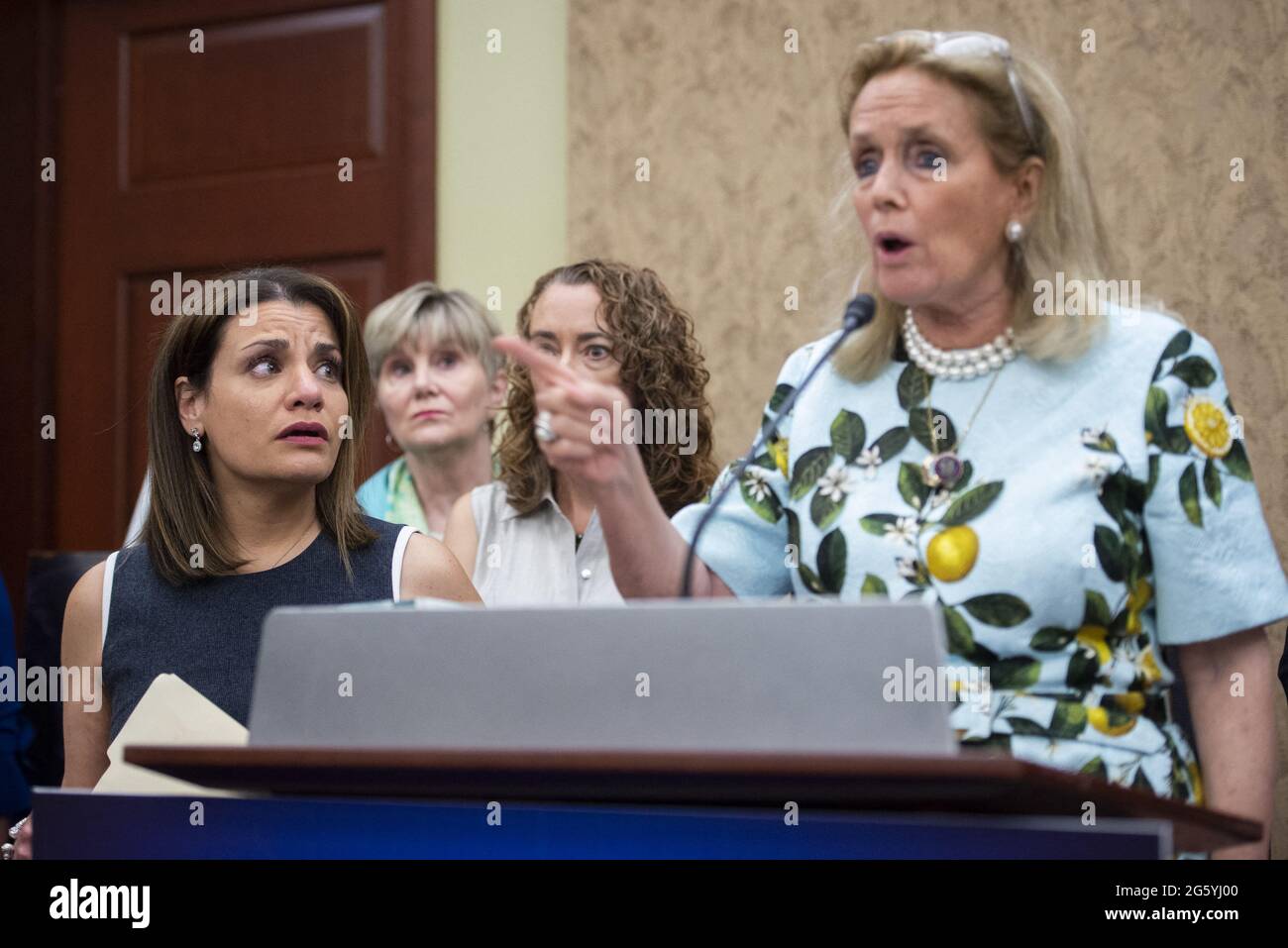 Rana Abbas Taylor, left, listens while United States Representative ...