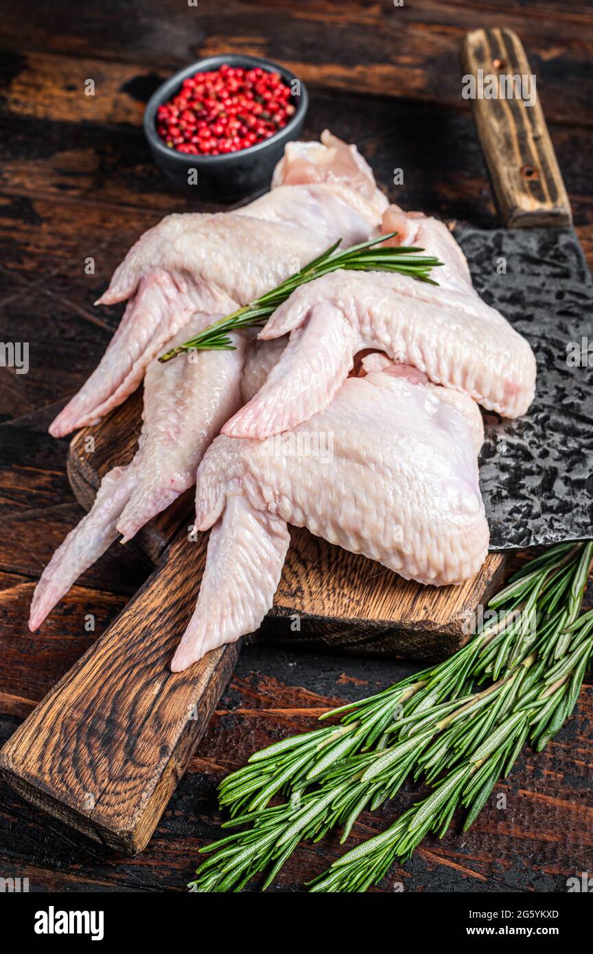 Uncooked Raw chicken wings Poultry meat on a butchery board with meat ...