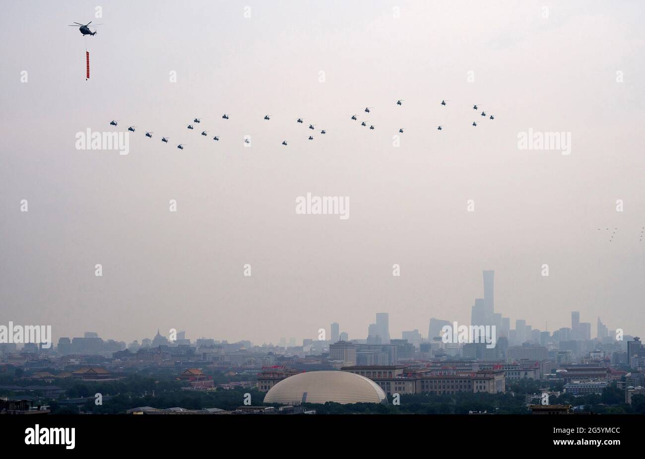 Beijing, China. 1st July, 2021. Helicopters fly in the formation of ...