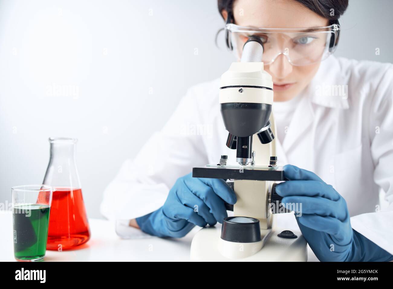 laboratory assistant looking microscope science research microbiology ...