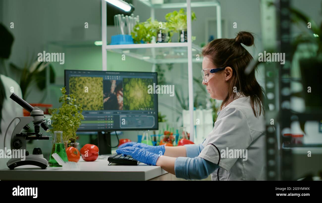 Scientist woman researcher typing biochemistry expertise on computer ...