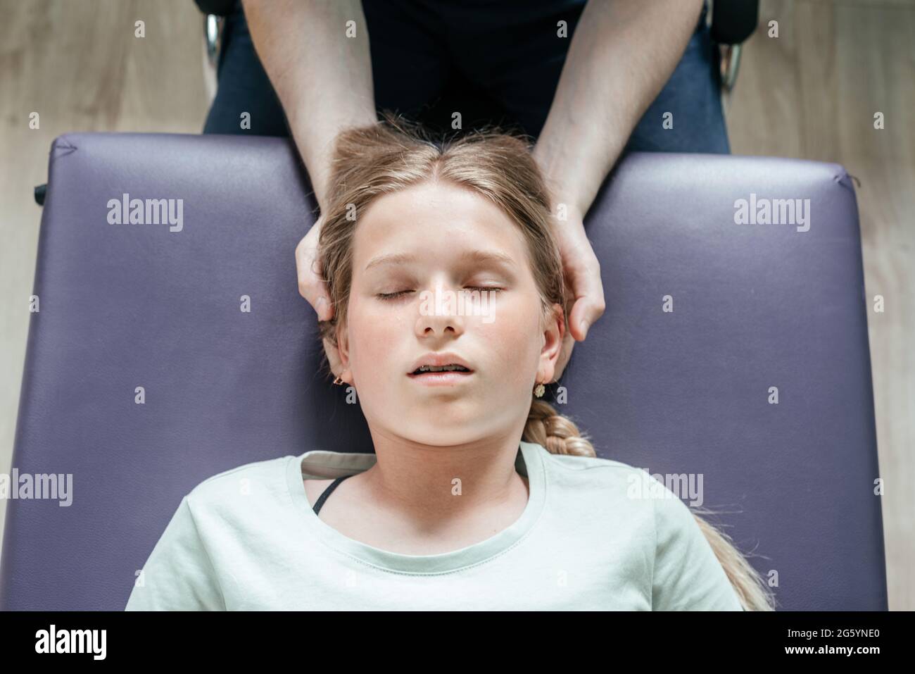 Craniosacral therapy practitioner giving a female patient CST ...