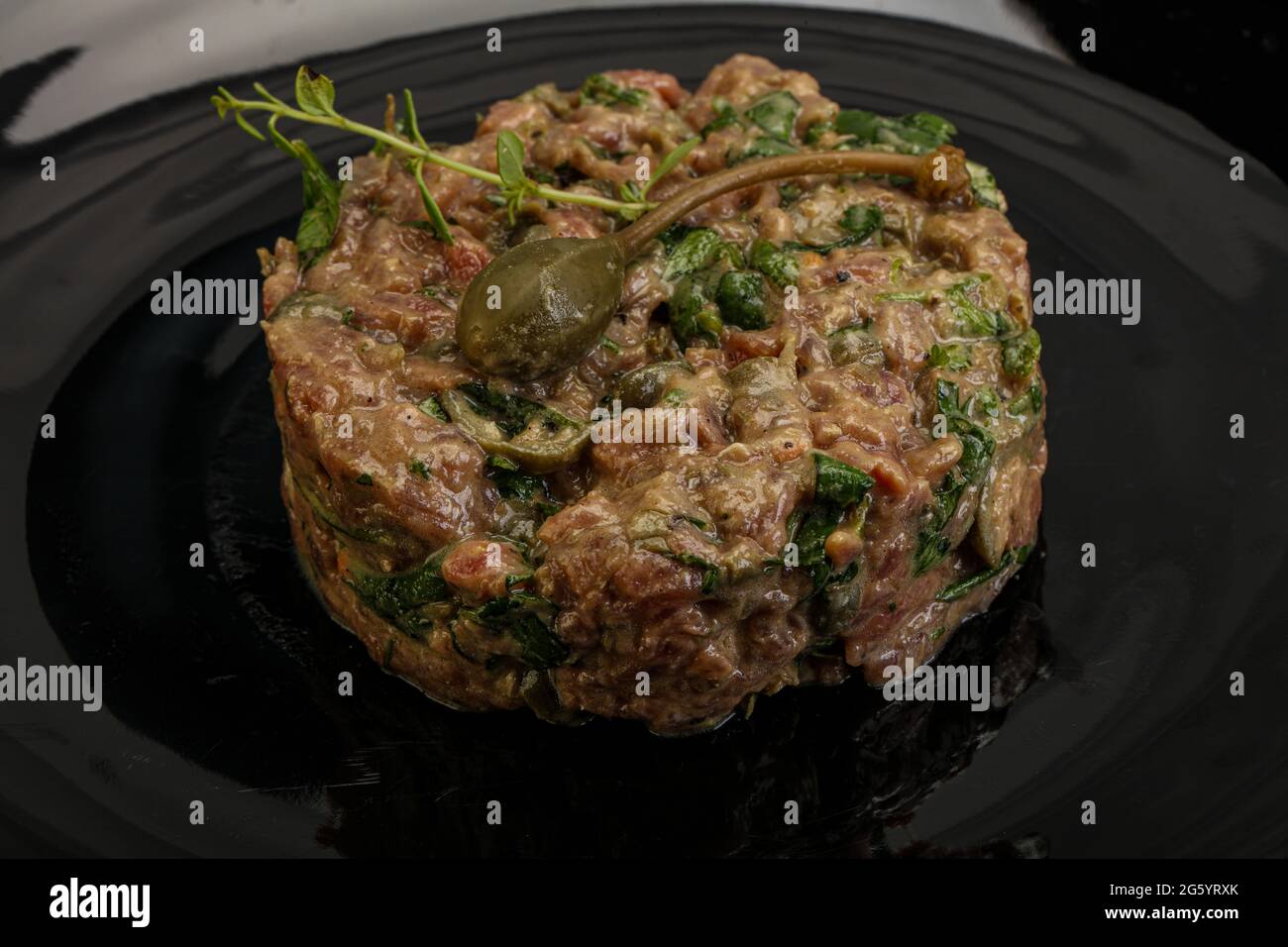 Raw beef tartar snack with capers Stock Photo - Alamy