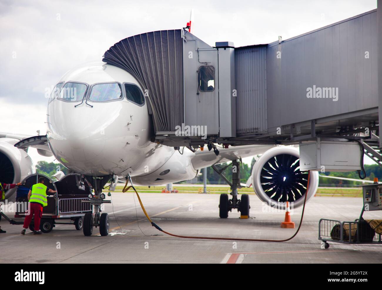 Refueling the aircraft at the airport before departure. The white plane ...