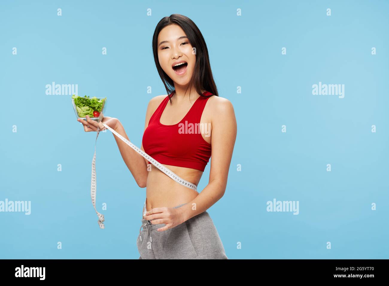 slender woman plate salad healthy food blue background Stock Photo - Alamy