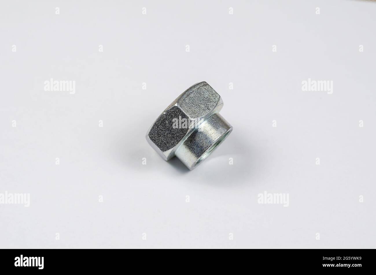 Hub nut on white background. New Silver front car hub nut. Auto parts ...