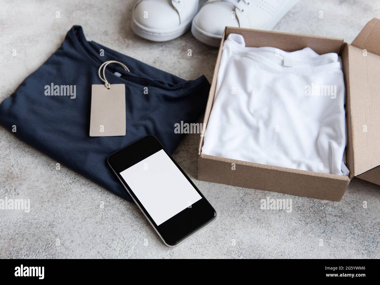 Clothes in an open cardboard box. Online shopping concept. Delivery of ...