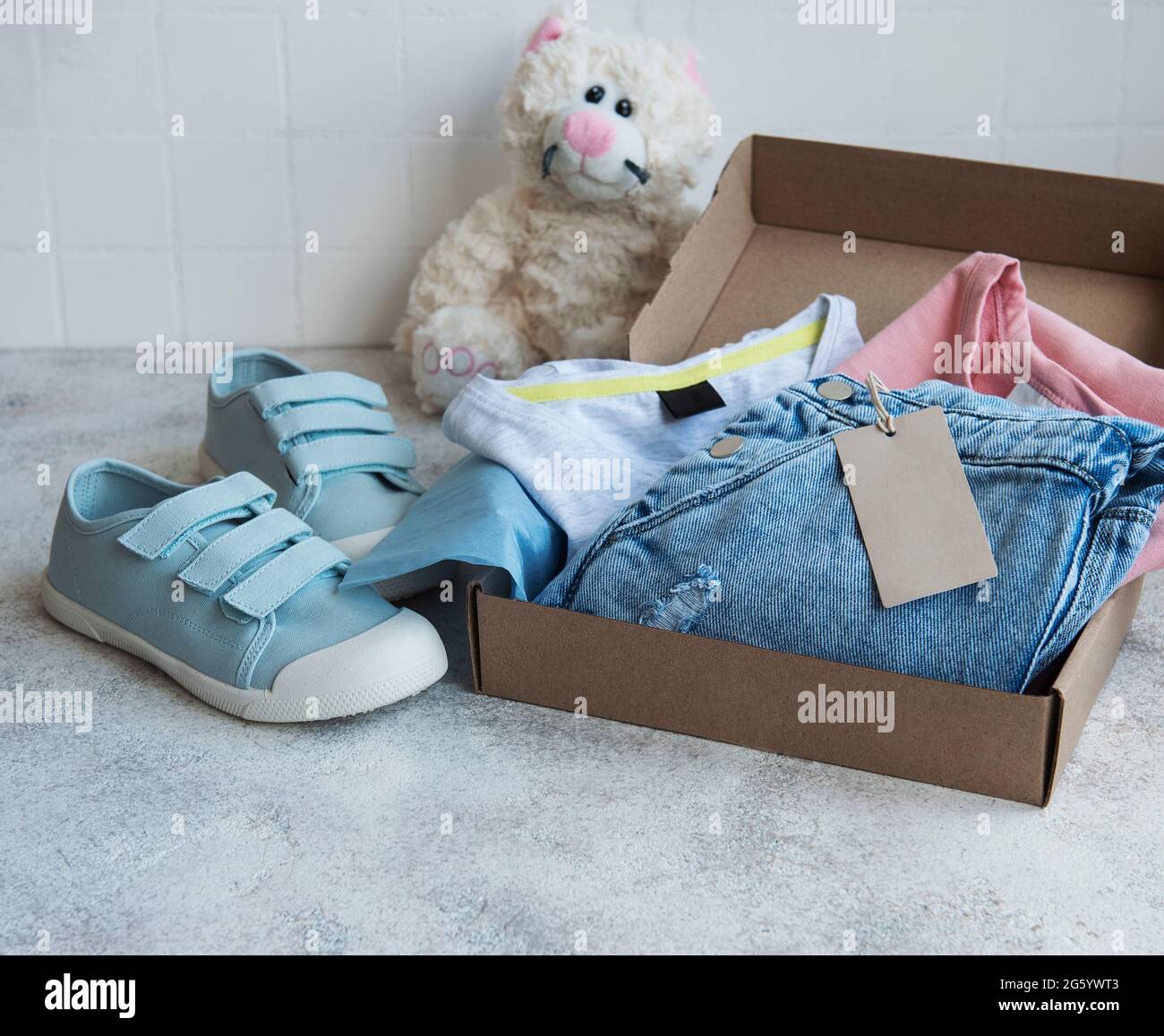 Clothes for kids in an open cardboard box. Online shopping concept ...